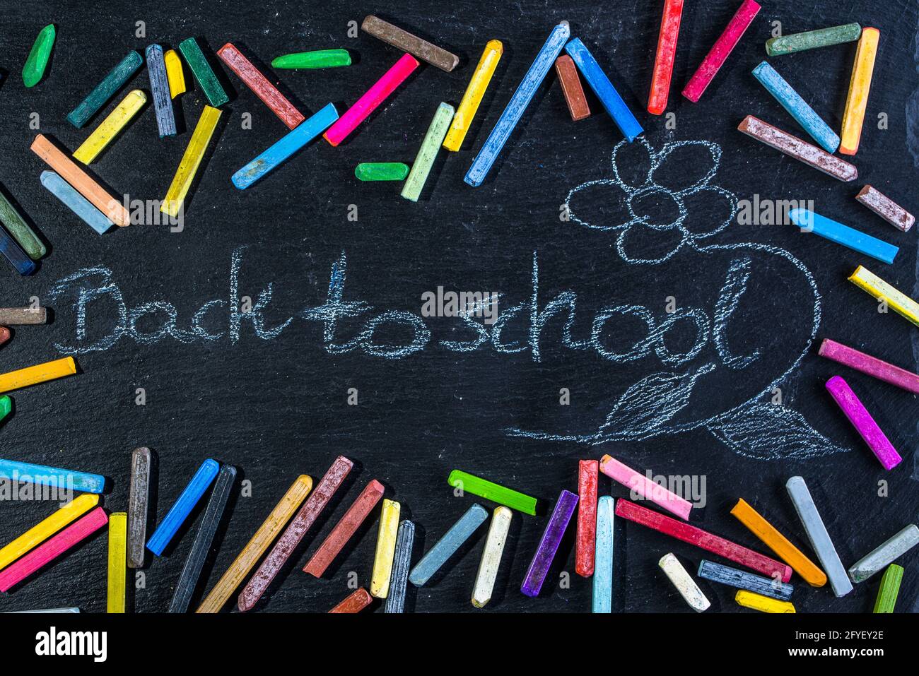 Black Chalkboard with back to school text written with white chalk on ...