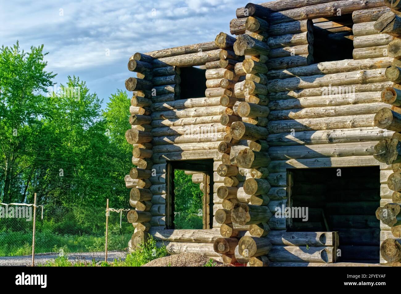 unfinished two-story log house, in summer Stock Photo - Alamy