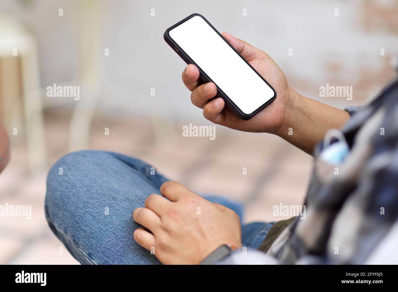 Side view of male hand holding smartphone include clipping path screen ...