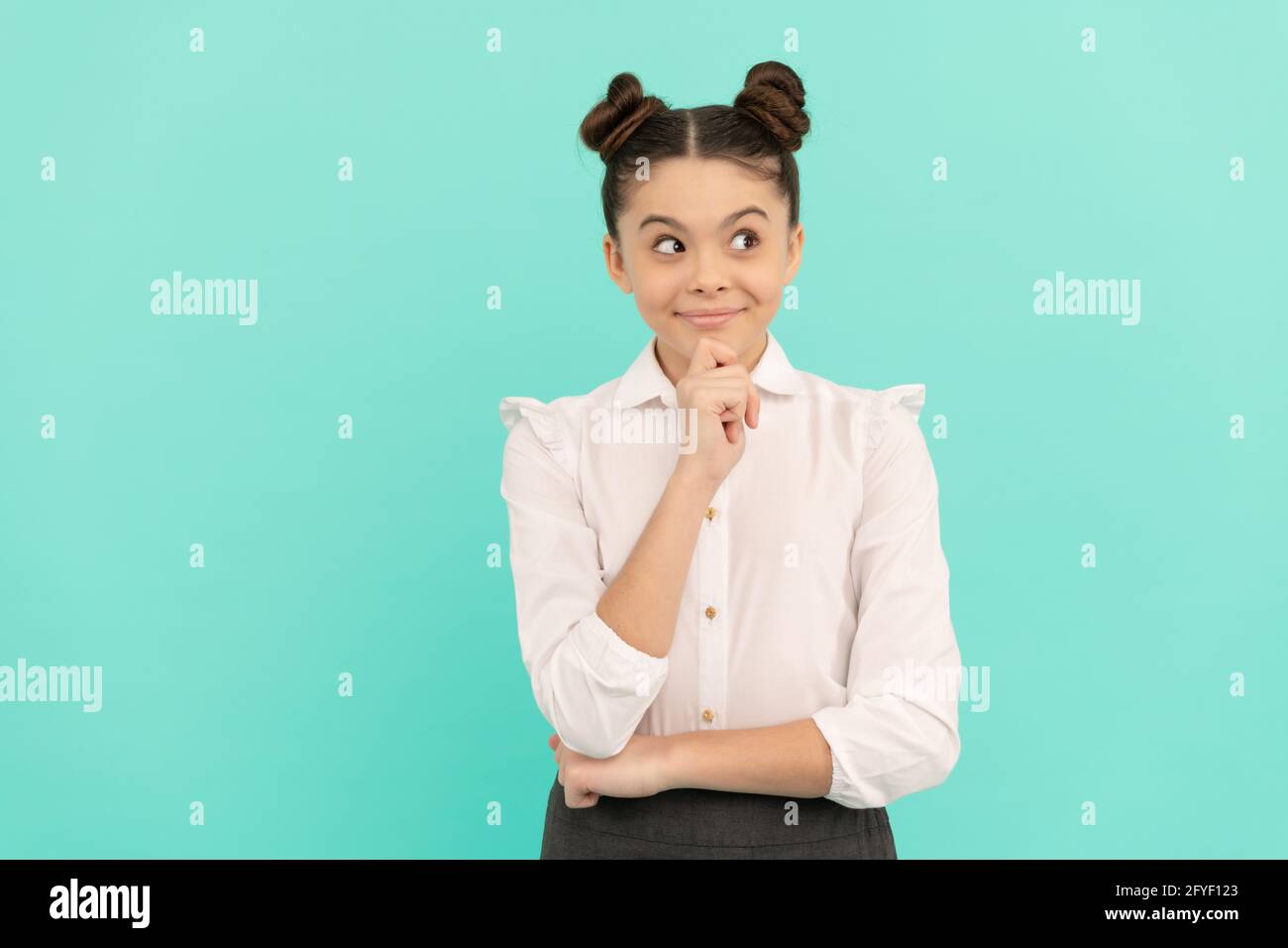 Happy primary school kid think looking away blue background, thinking ...