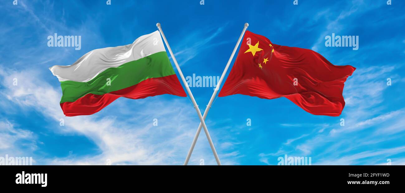 flags of China and Bulgaria waving in the wind on flagpoles against sky ...
