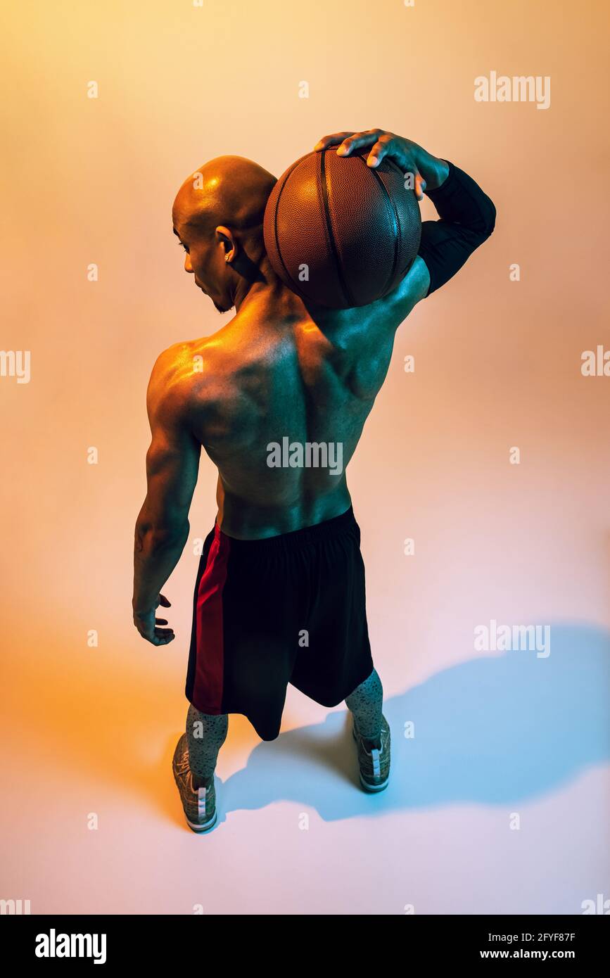 Sportive muscular african-american male basketball player posing in ...