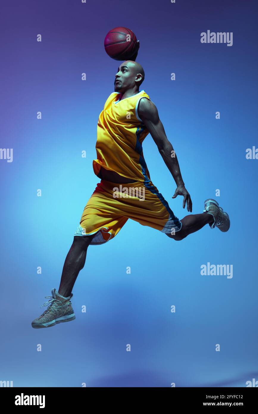 Handsome african-american male basketball player in action and motion ...