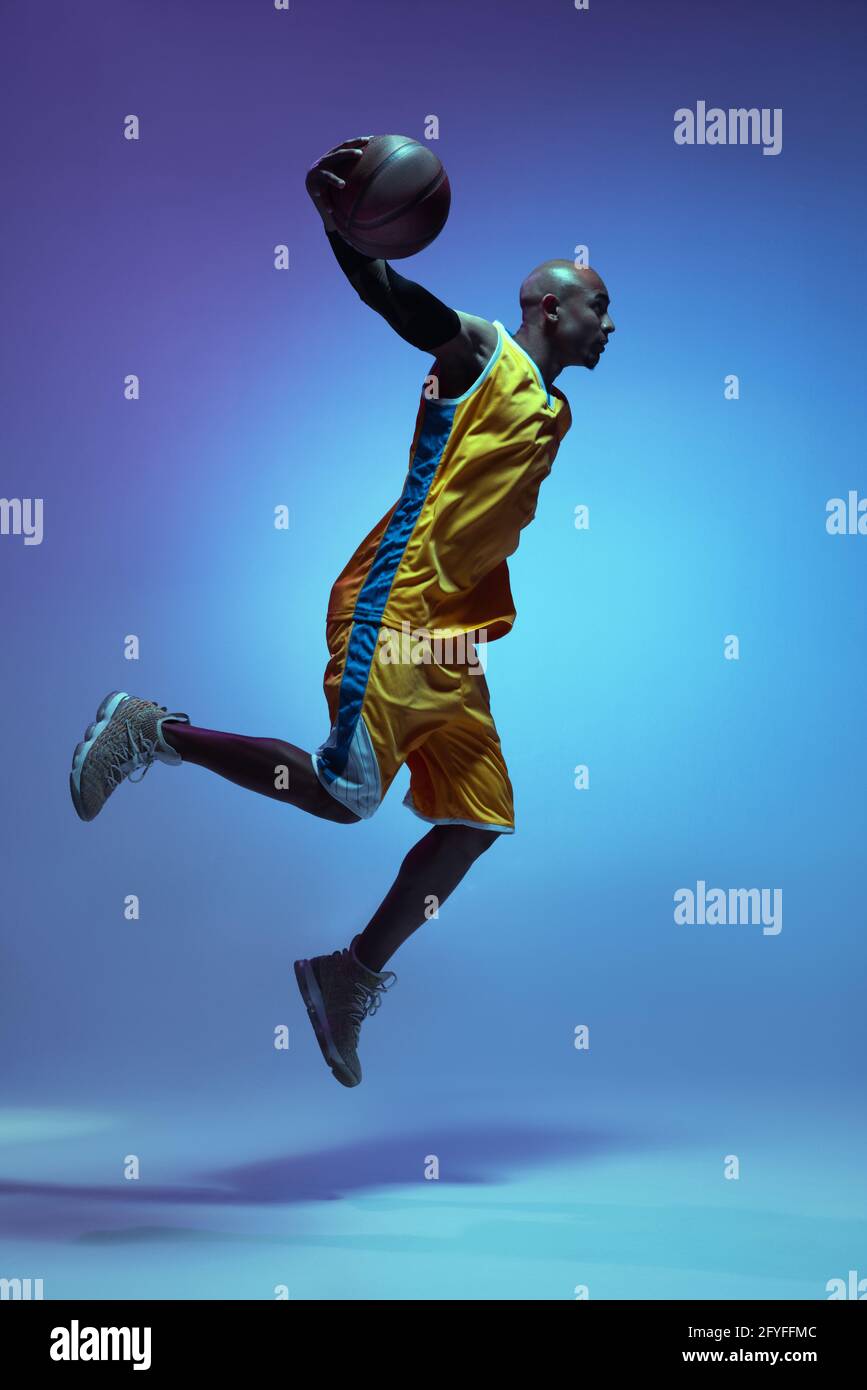 Handsome african-american male basketball player in action and motion ...