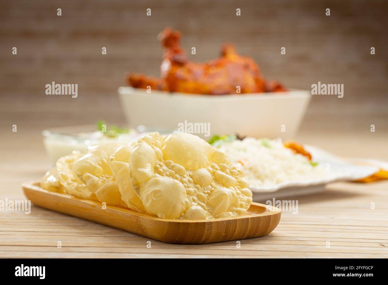 Kerala Papadum or plain pappadom or Appalam ,arranged in a wooden board ...