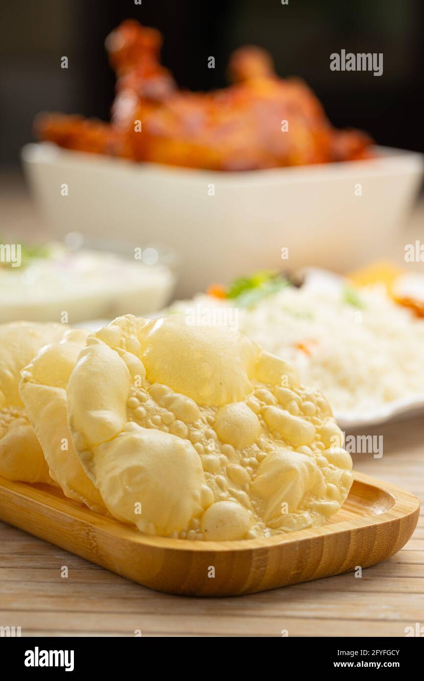 Kerala Papadum or plain pappadom or Appalam ,arranged in a wooden board ...