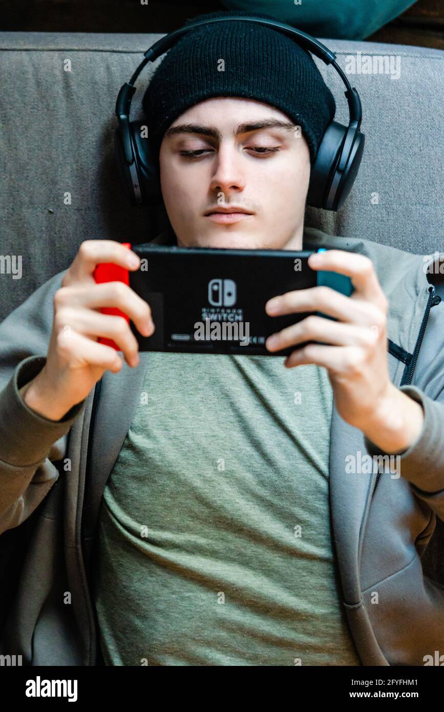 Young man playing a video game on a Switch, France Stock Photo - Alamy