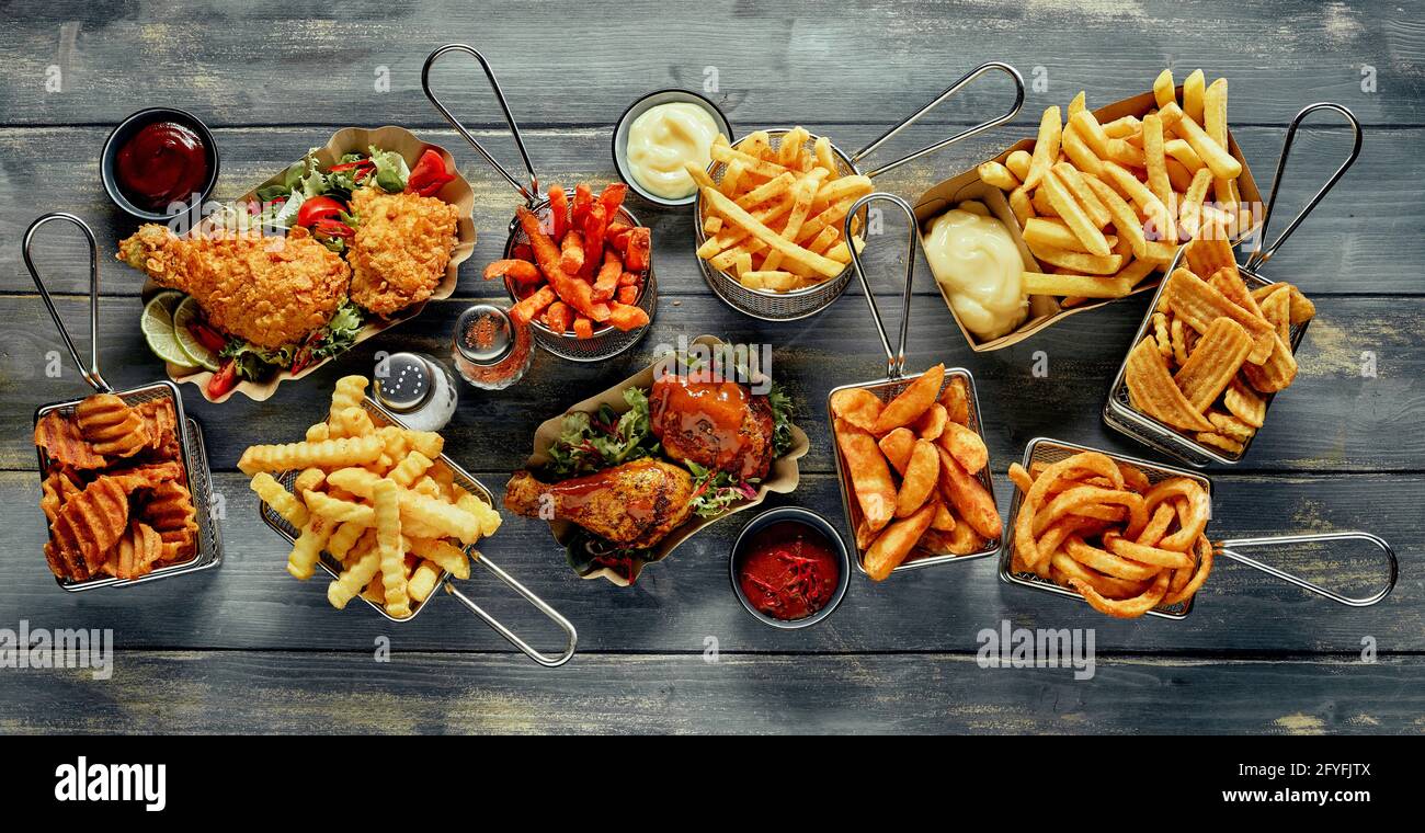 Top view of delicious junk food including crispy chicken and French ...