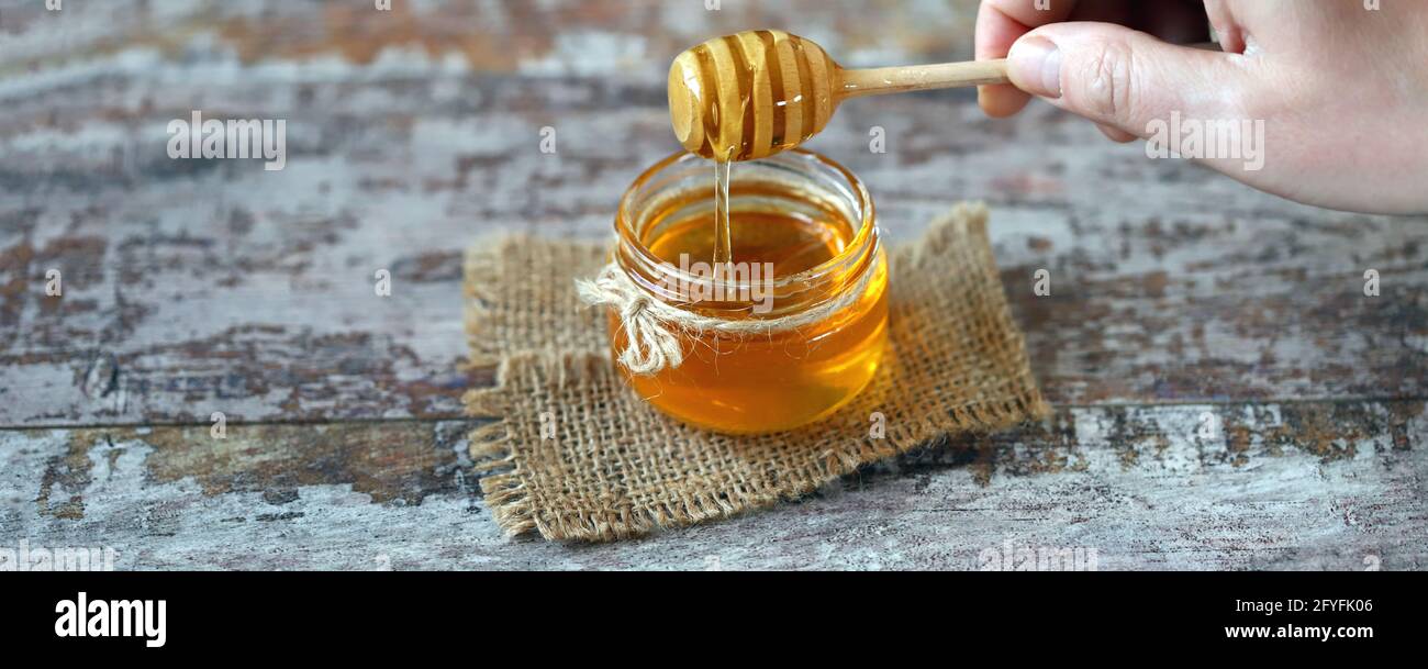 Jar of honey. Stick for honey Stock Photo - Alamy