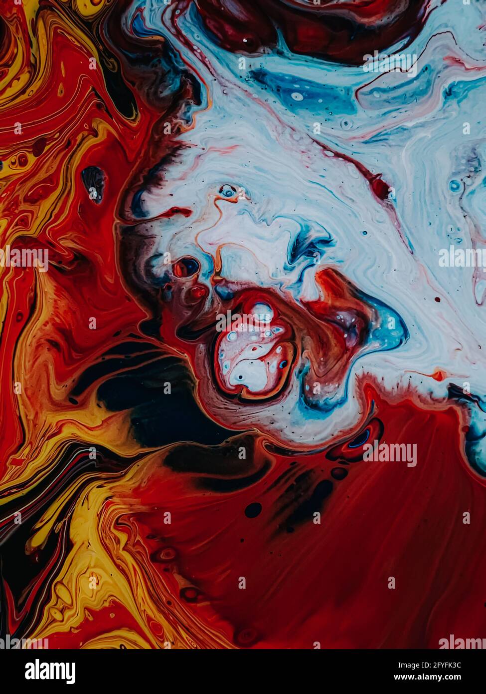 Vertical shot of an abstract painting with mixed oil paint colors ...