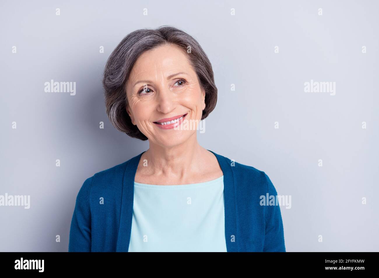 Photo portrait of elder woman smiling looking blank space isolated on ...