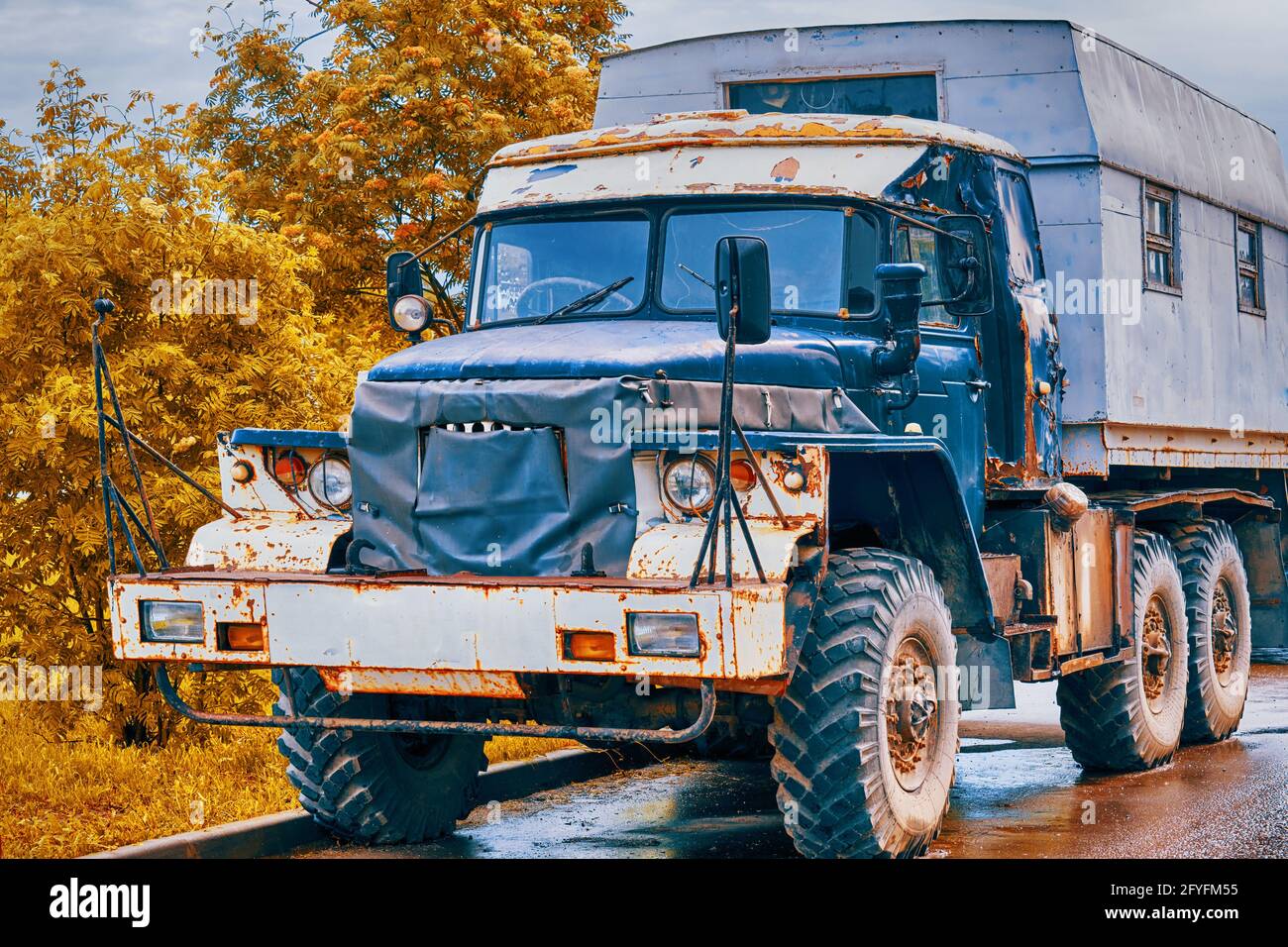 Vintage truck with patches on the cab and a living compartment in the ...