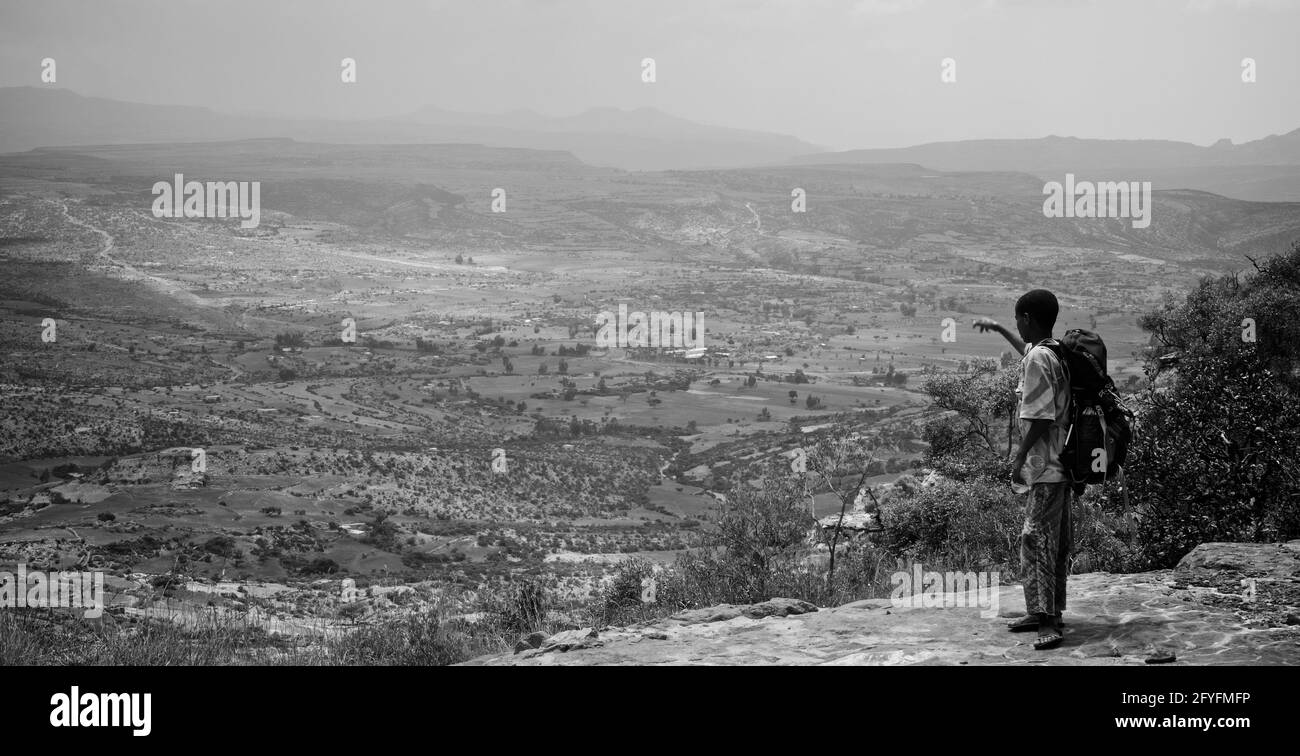 Guiding boy looking at the Ethiopian plateau from the viewpoint of the ...
