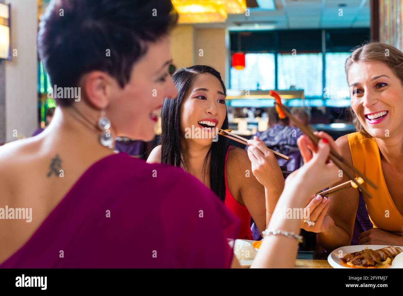 Young people eating in Asia restaurant Stock Photo - Alamy