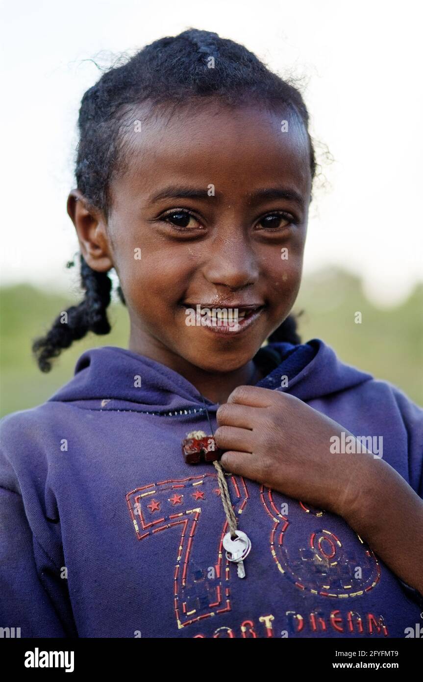 Ethiopian little girl smiling, dressed with a hoody and wearing a ...