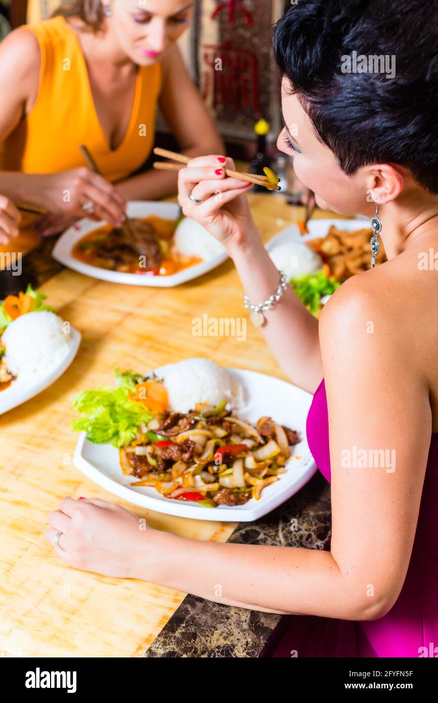 Young people eating in Asia restaurant Stock Photo - Alamy
