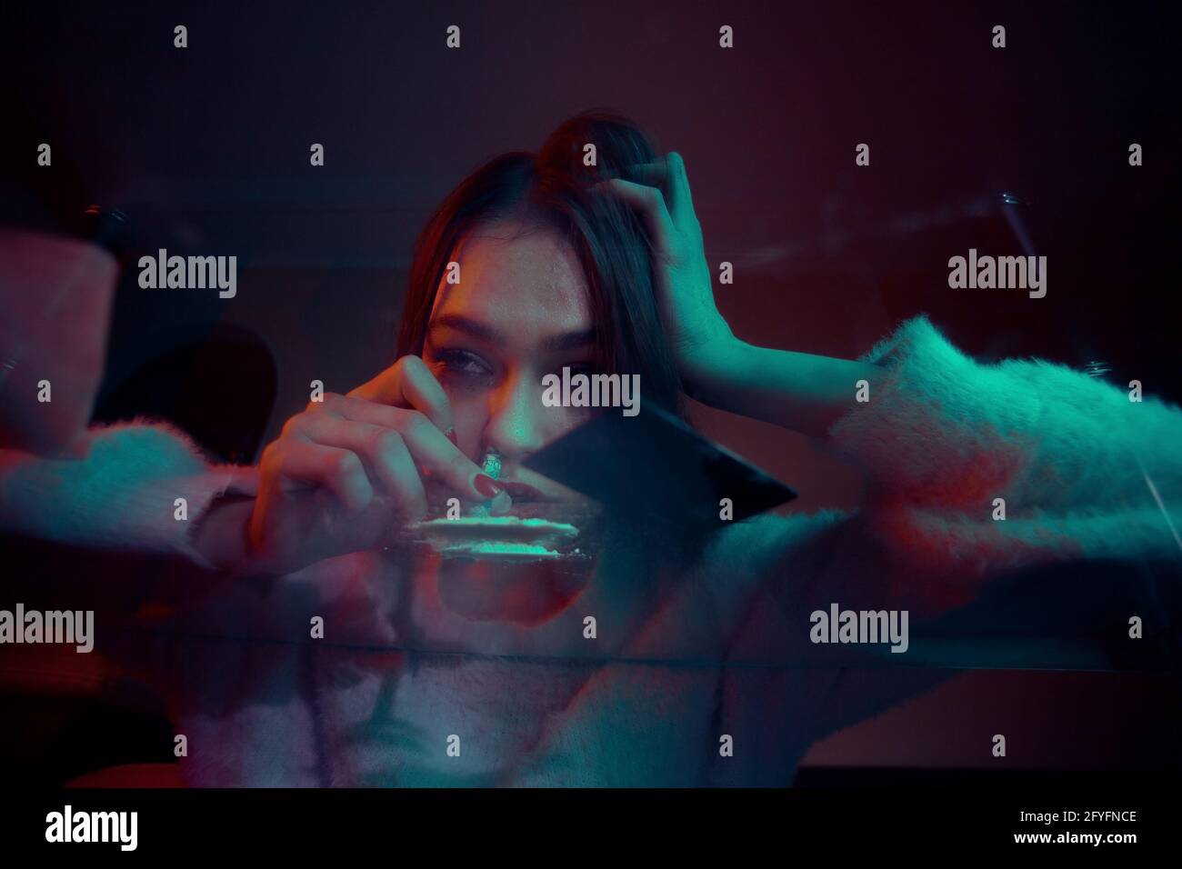 Portrait of a girl sniffing a line of white drug cocaine powder. Addict ...