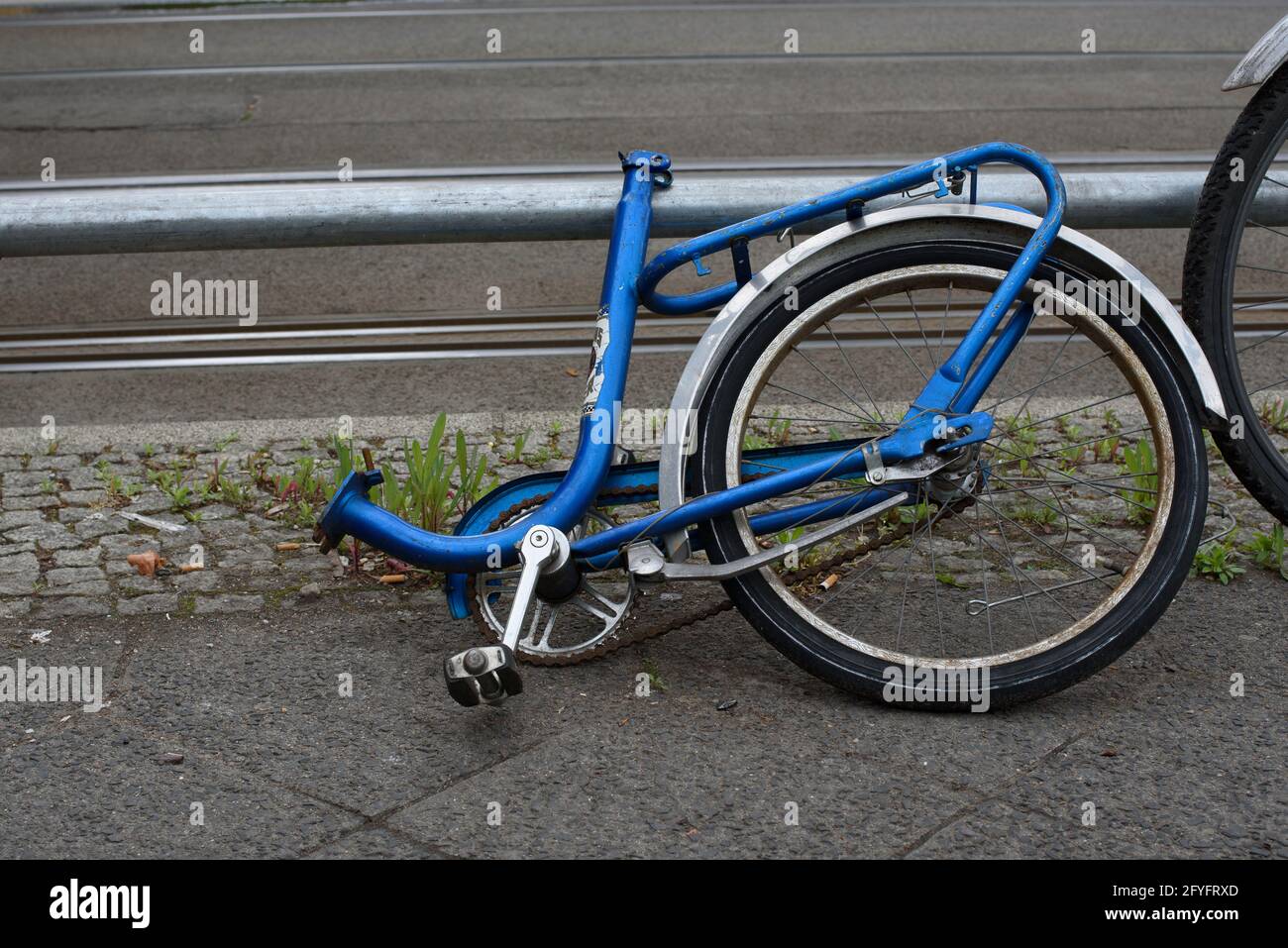 An old junk bike attached to a railing, old junk bike, a half bike ...