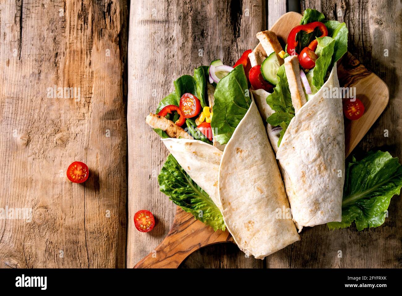 Traditional mexican tortila wrap with pork meat and vegetables on ...