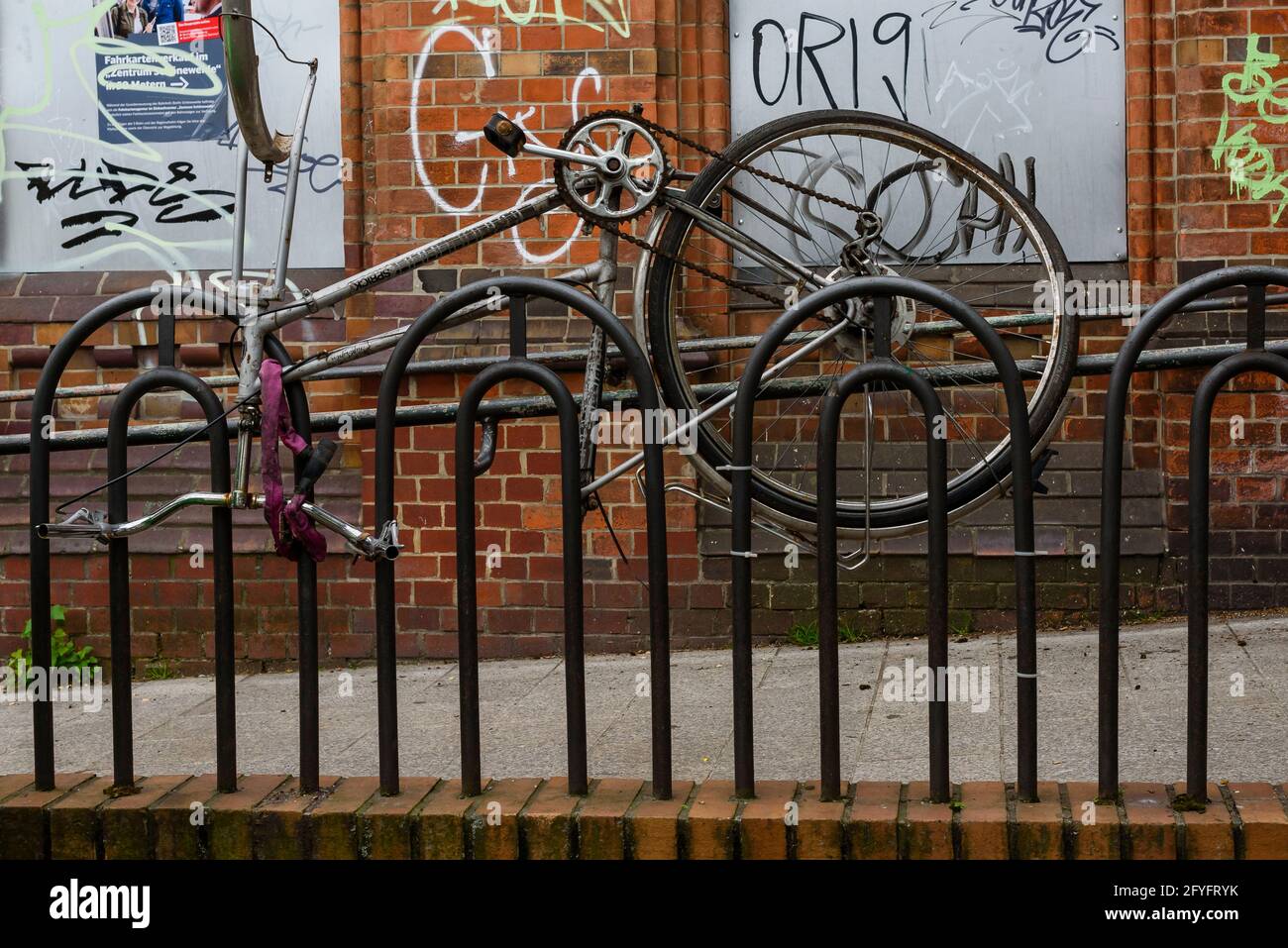 An old junk bike attached to a railing, old junk bike Stock Photo - Alamy