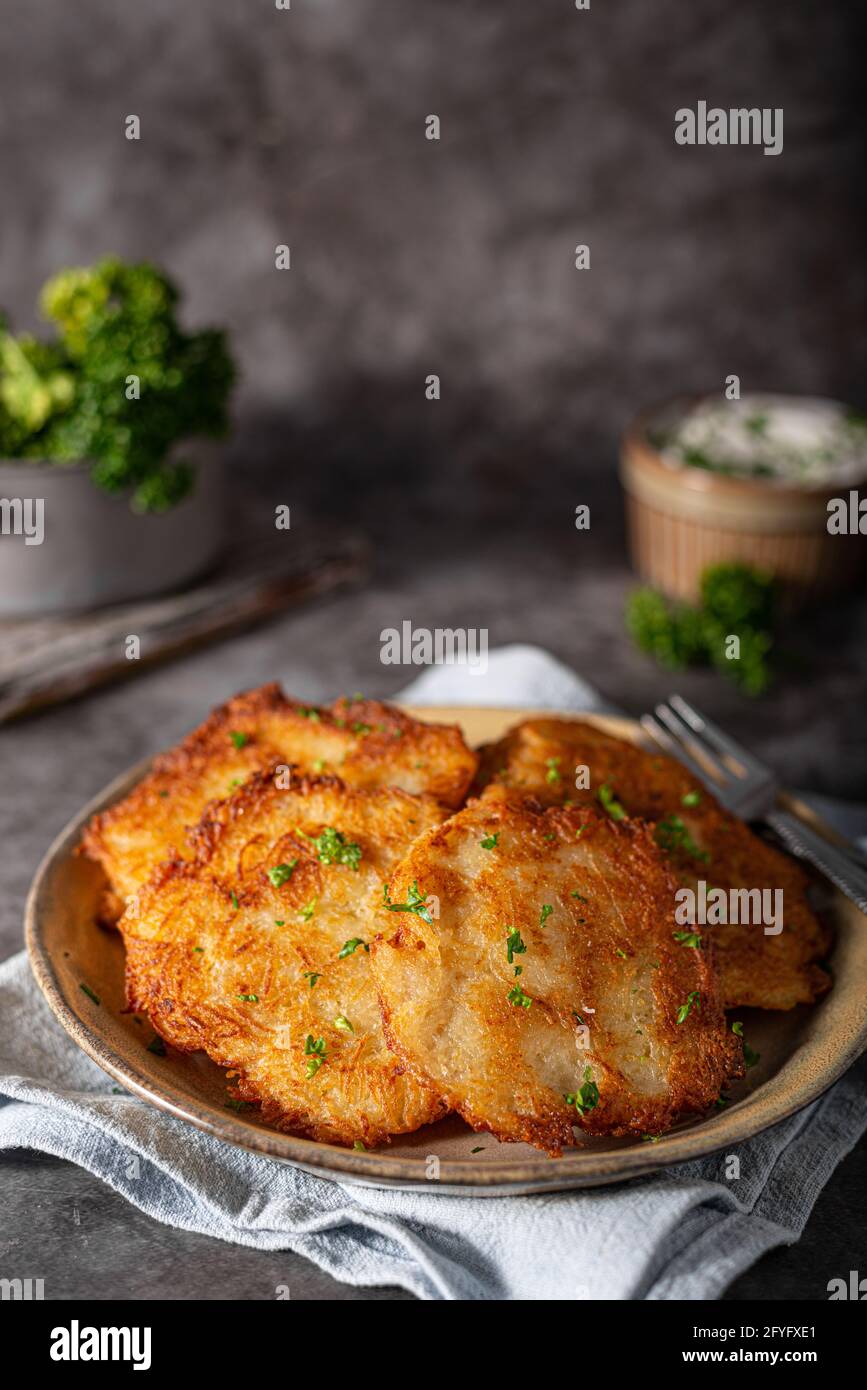 Homemade potato latkes with garlic sour creame and fresh herbs Stock ...