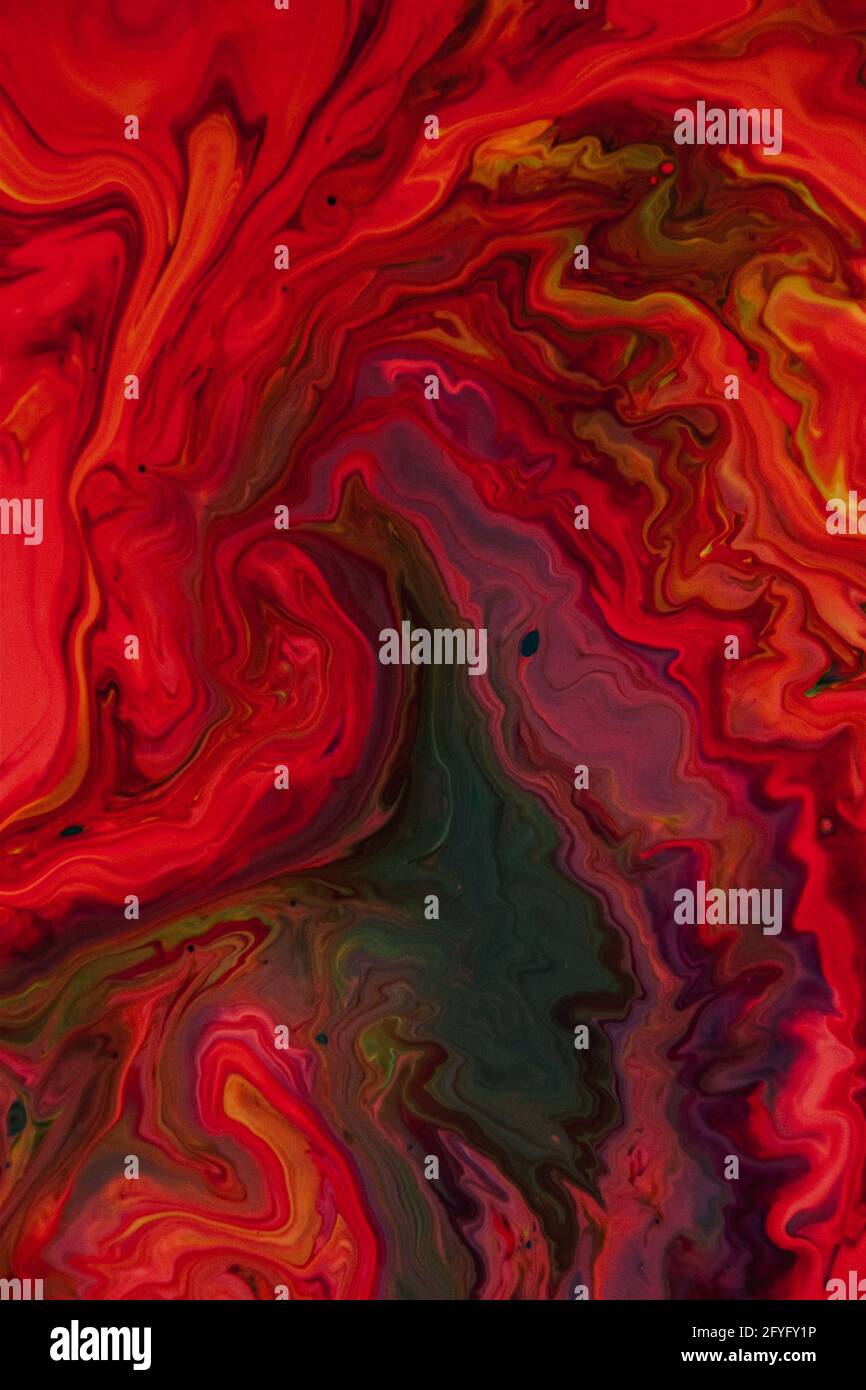 Vertical shot of an abstract painting with mixed red oil paint colors ...