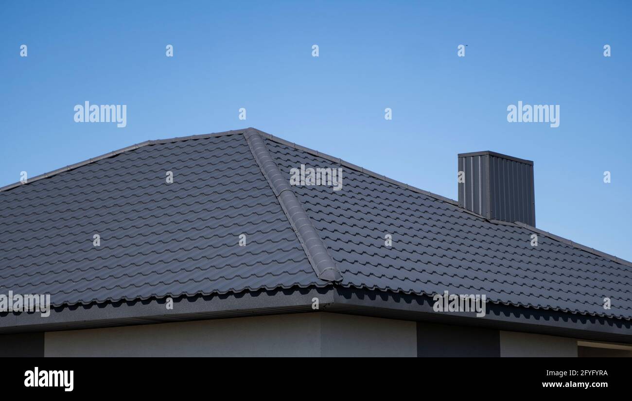 Brown corrugated metal profile roof installed on a modern house. The ...