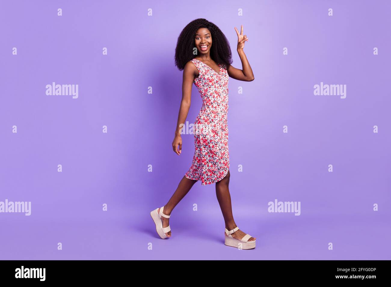 Full length body size side profile photo of smiling girl showing v-sign ...
