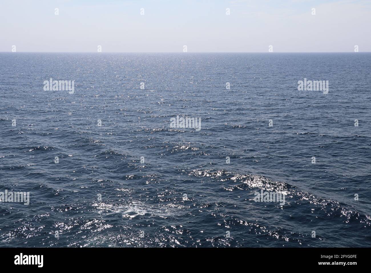 blue water of a very quiet ocean and cloudless blue sky above Stock ...