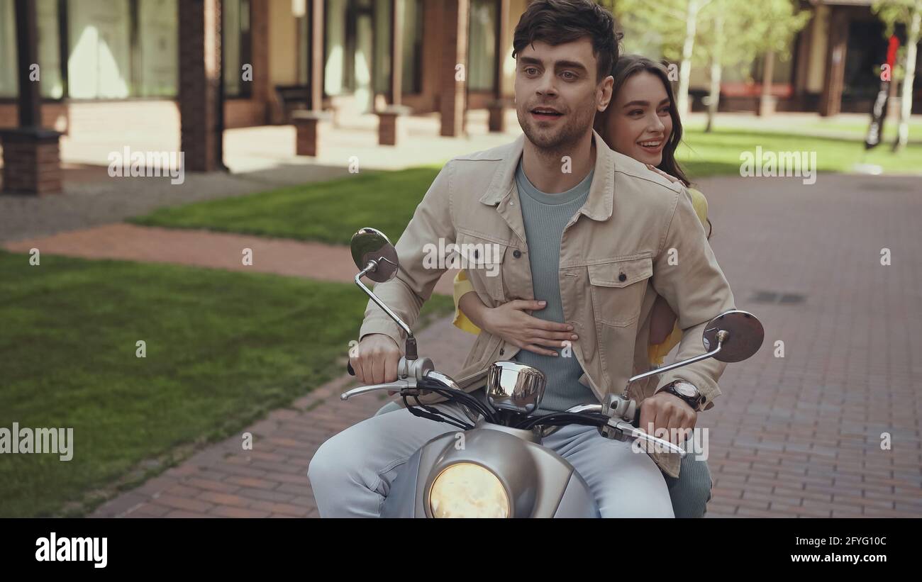 cheerful couple riding motorcycle outside on street Stock Photo - Alamy