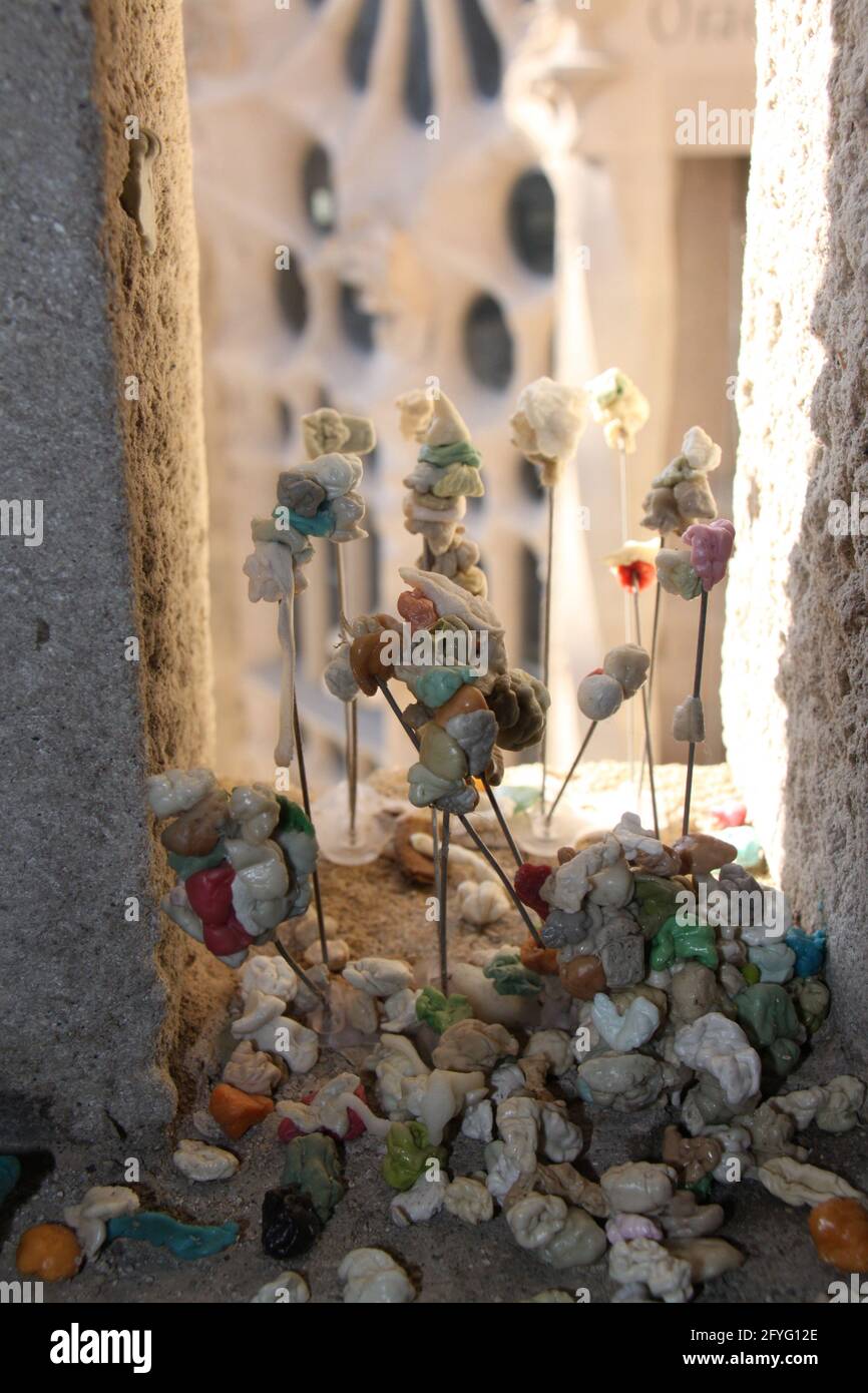 different colors of chewed up chewing gum piled on sticks in a window ...