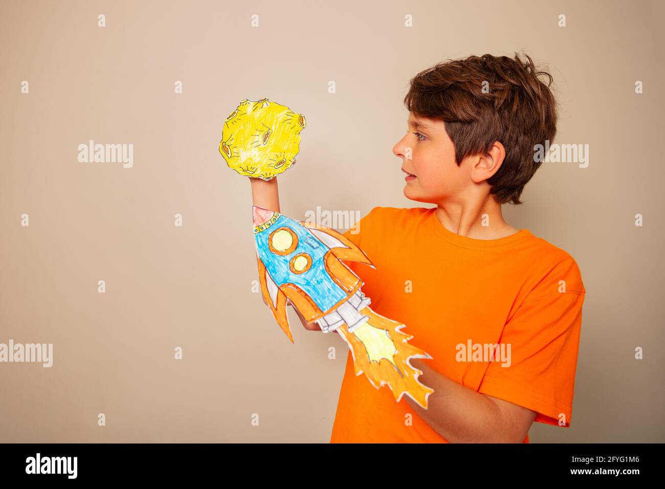 Cute young boy play with rocket land on a planet Stock Photo - Alamy