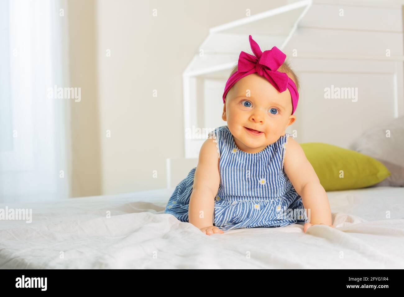 Portrait of a beautiful baby girl in dress and bow Stock Photo - Alamy