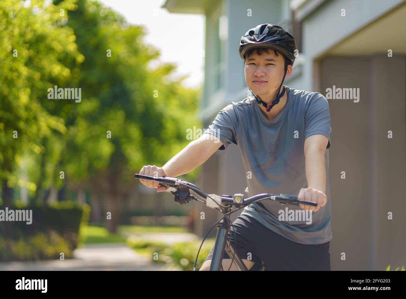 Asian woman looking happy while bike ride around her neighborhood for ...