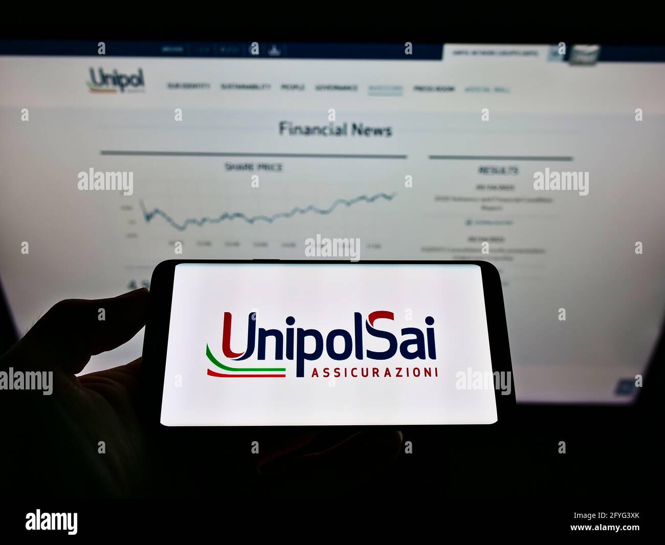 Person holding smartphone with logo of Italian company UnipolSai ...