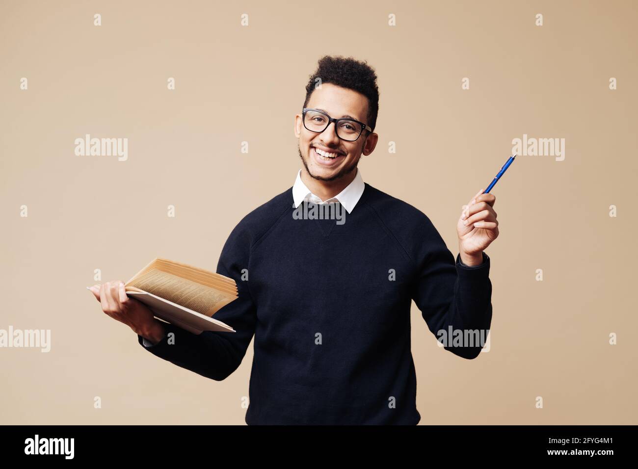 Young Professor holding a book while explaining wearing glasses on ...