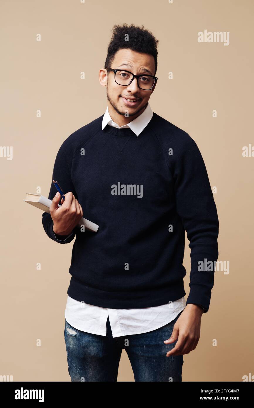 Young Professor holding a book while explaining wearing glasses on ...