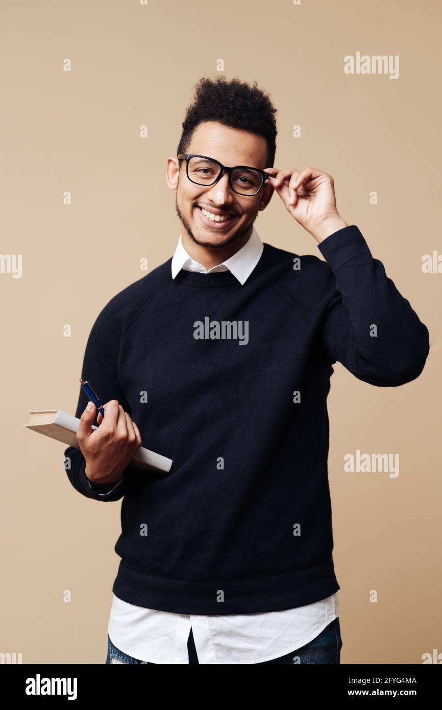 Young Professor holding a book while explaining wearing glasses on ...
