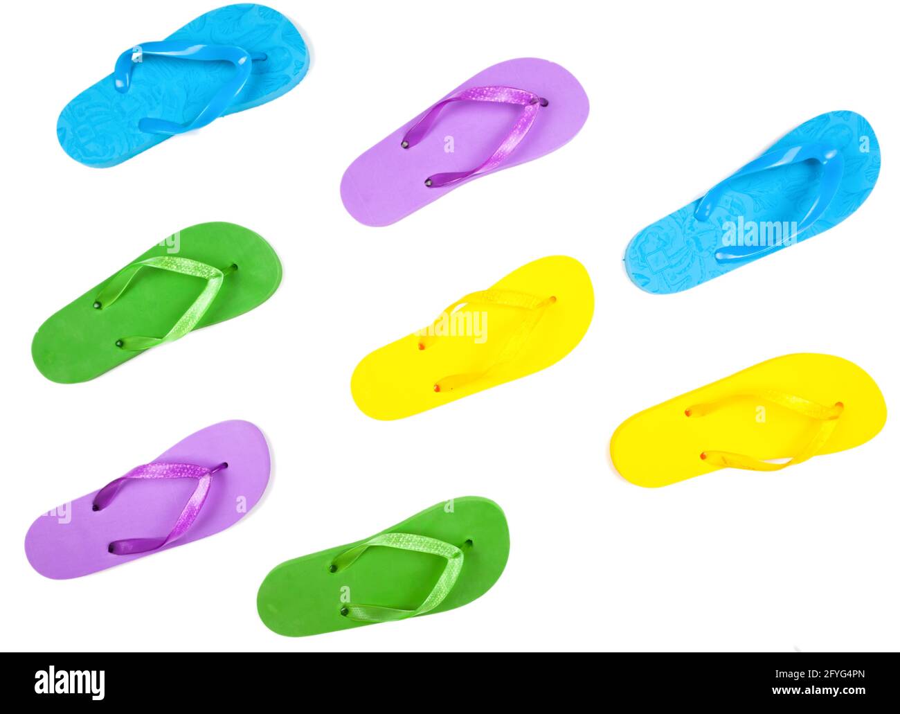 multi-colored rubber flip flops on a white background, view from above ...