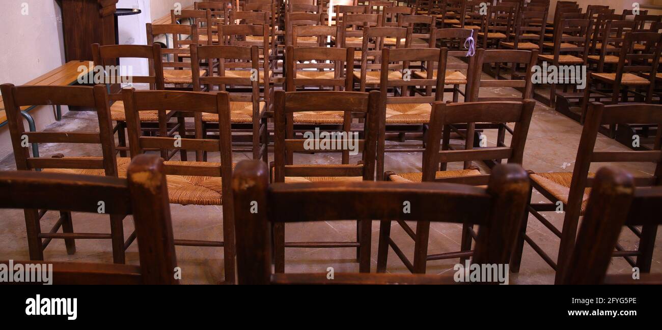 View on isolated old brown wood chairs with backrest in a row inside ...