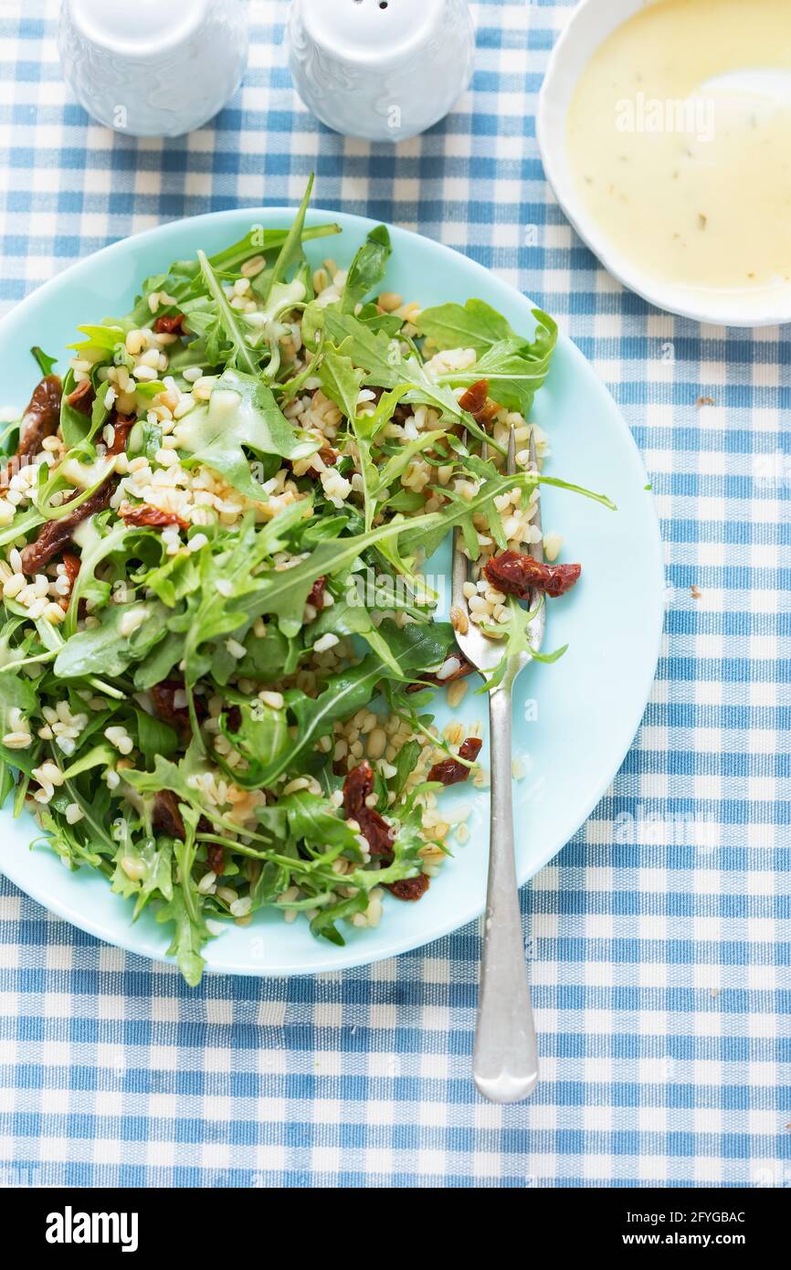 Bulgur, sun dried tomatoes and rocket leaves salad with vinaigrette ...