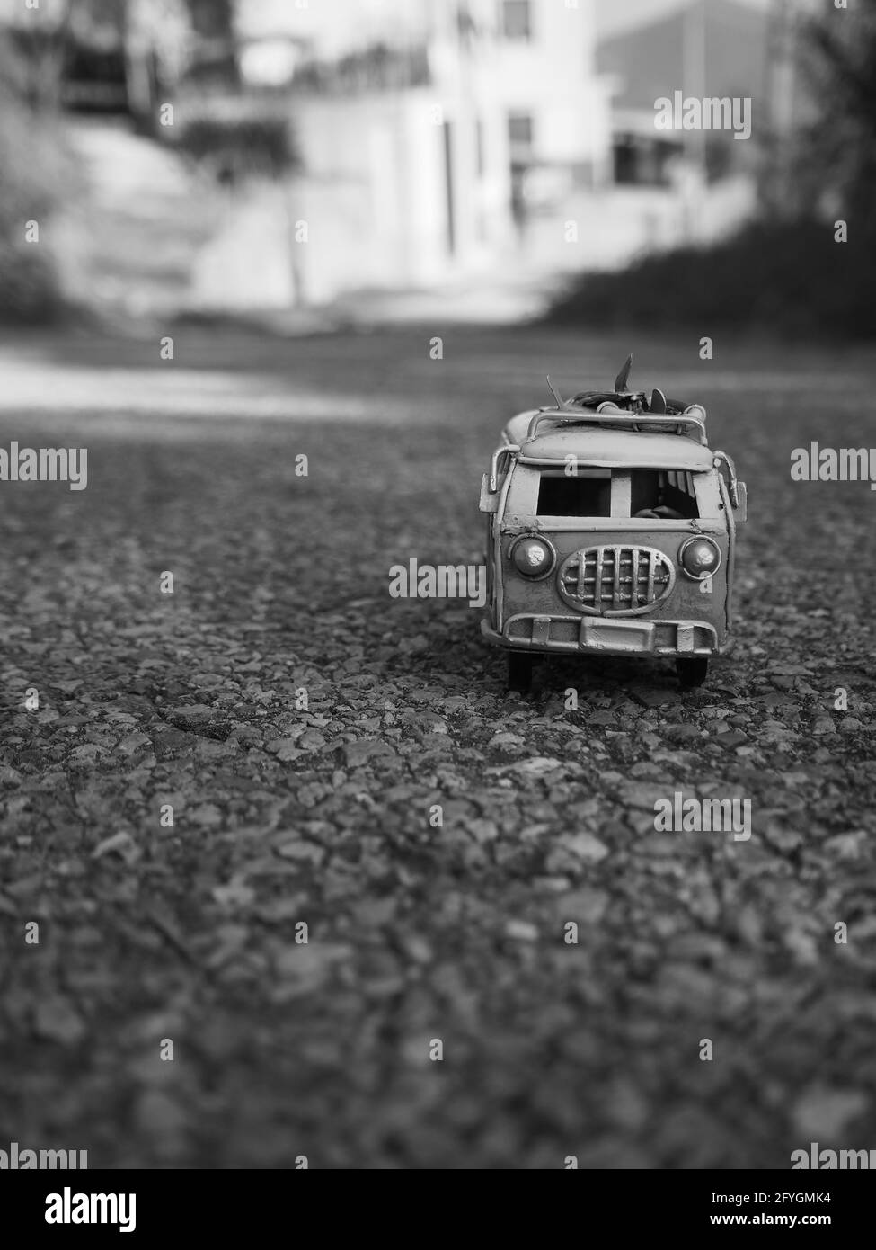Grayscale of vintage toy minibus on road Stock Photo - Alamy