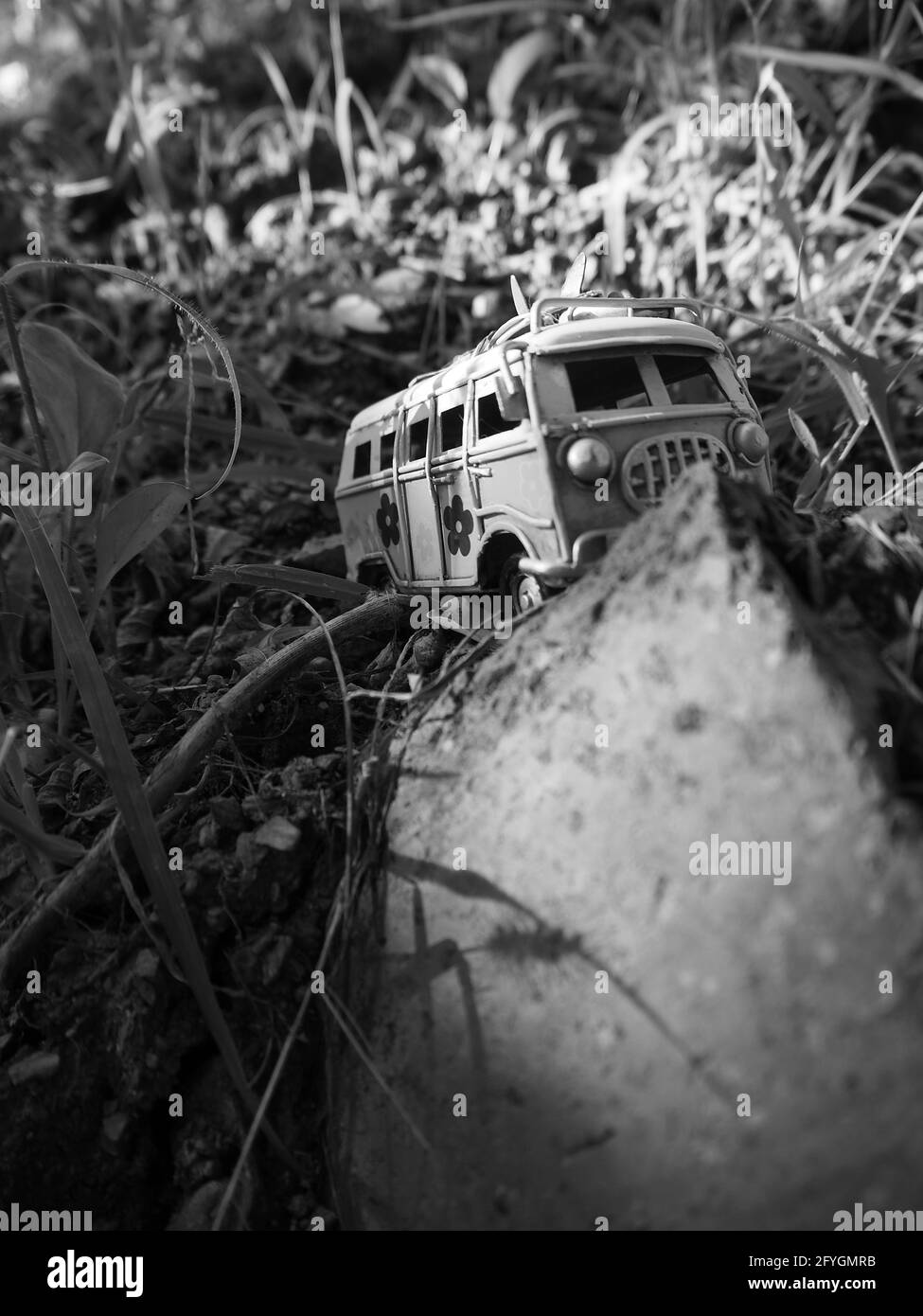 Grayscale of toy minibus by stone Stock Photo - Alamy