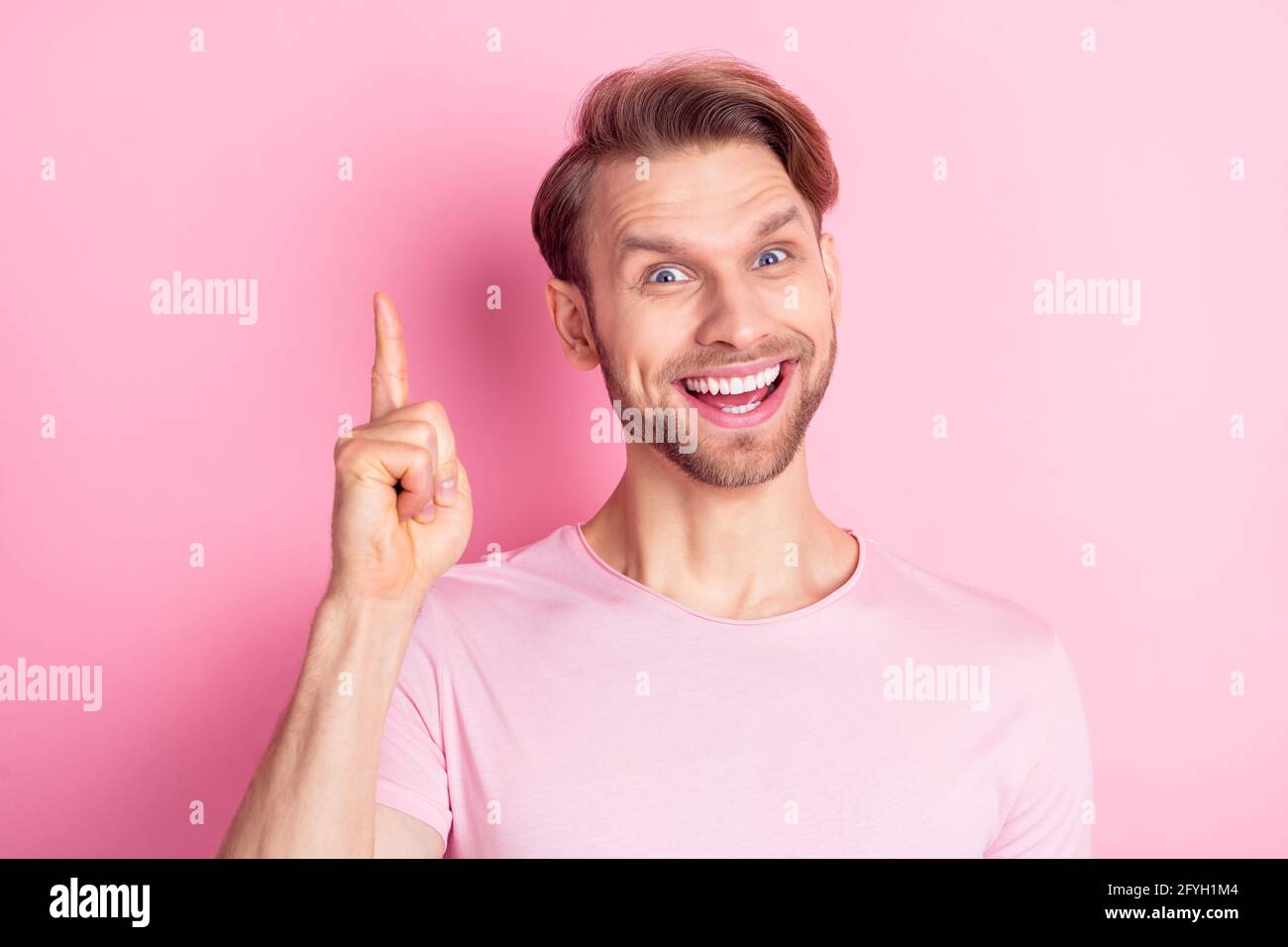 Portrait of astonished cheerful man point finger toothy smile look ...