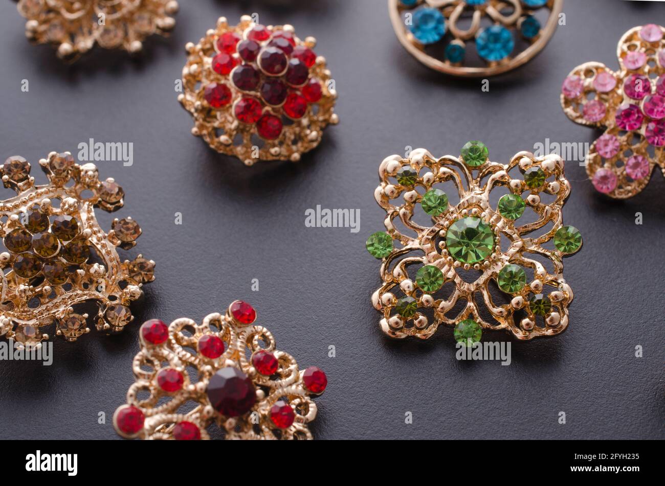 set of brooches isolated on black. background of many brooches Stock ...