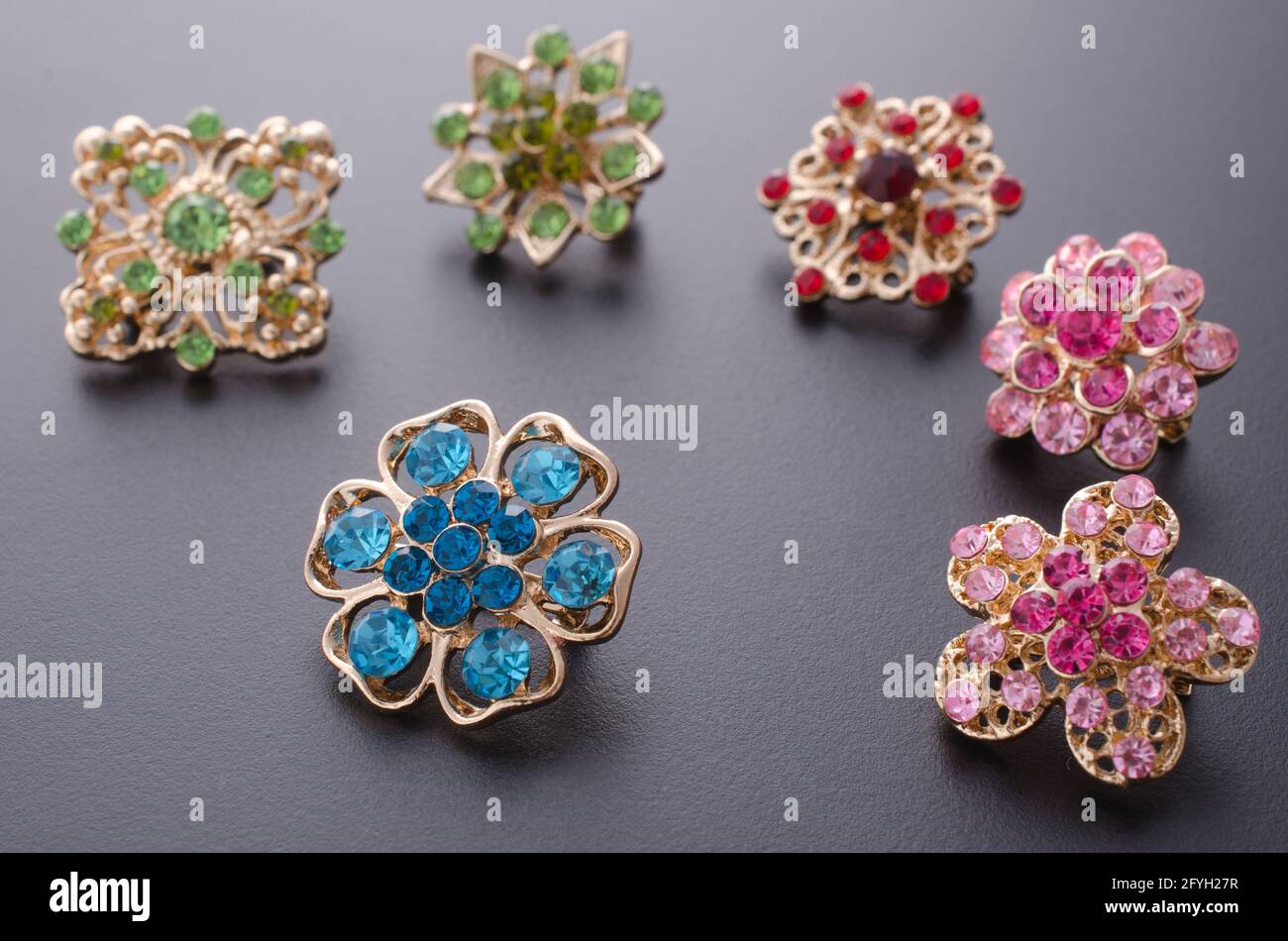 set of brooches isolated on black. background of many brooches Stock ...