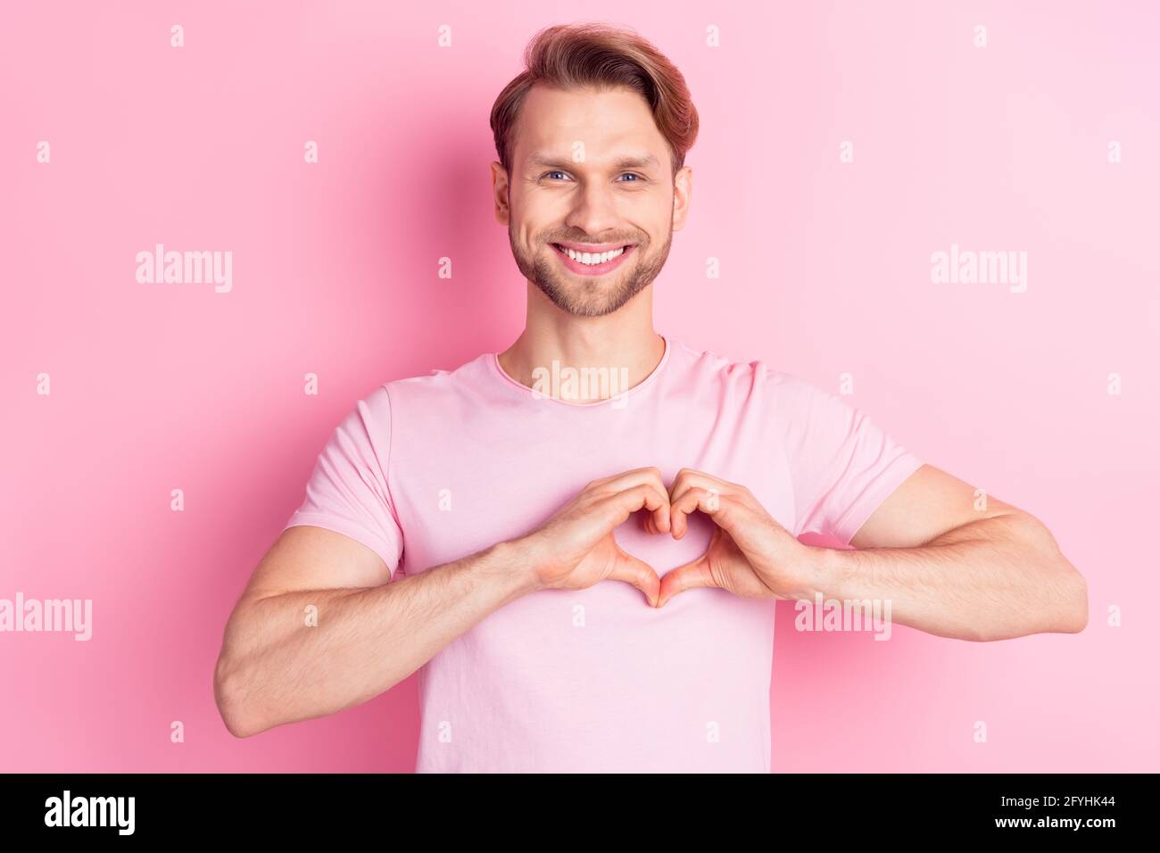 Portrait of cheerful man hands fingers make show heart figure toothy ...