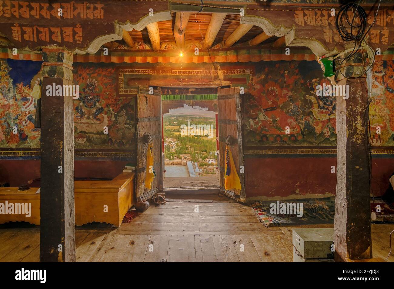 Ancient Thiksey monastery with view of murals on the inside wall and ...