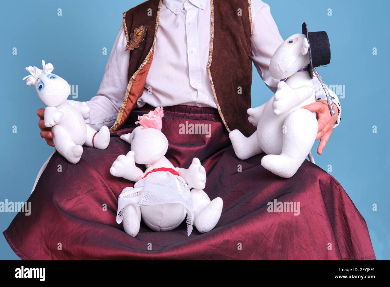 Actors with Moomin troll dolls on a blue background - Moscow, Russia ...