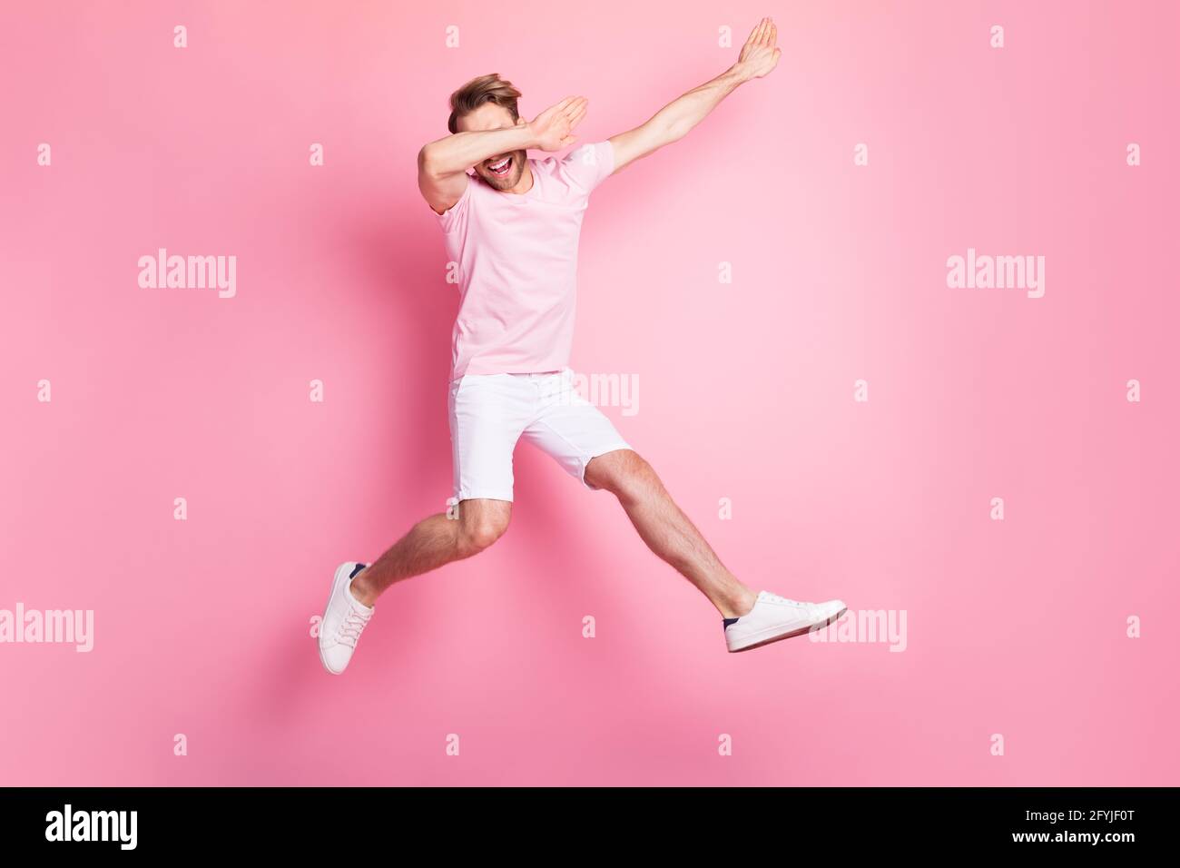 Full body portrait of cheerful excited man arms dabbing toothy smile ...
